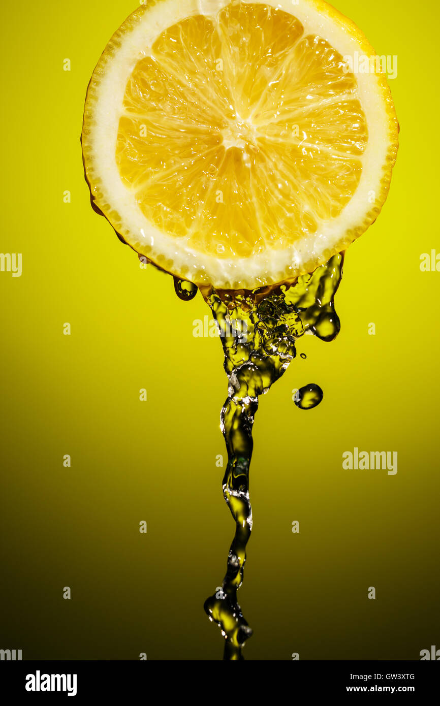 Fresh water drops on lemon at yellow background Stock Photo - Alamy