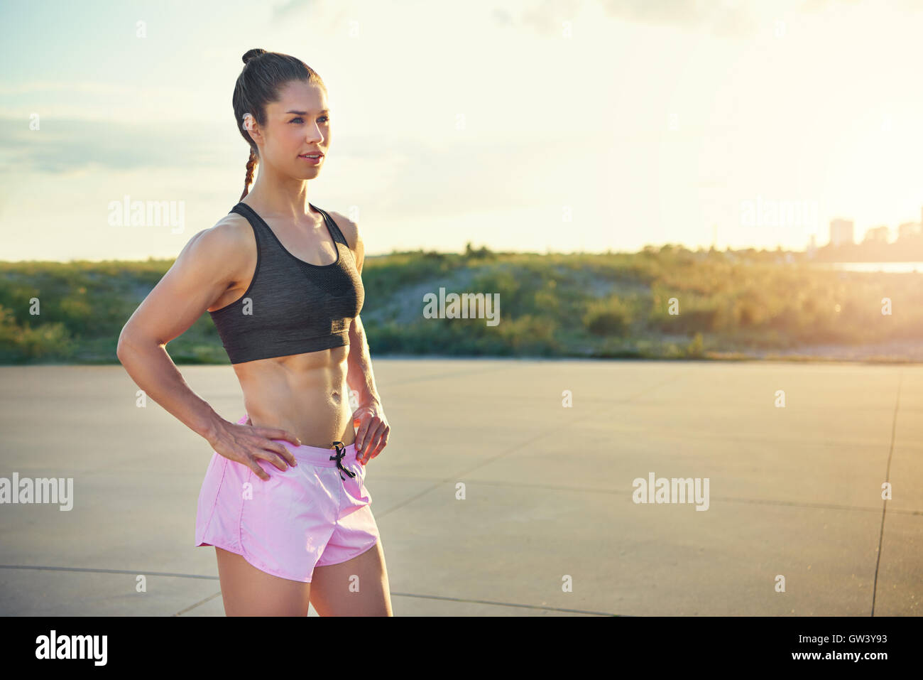 Toned healthy athletic young woman with a strong muscular body standing ...