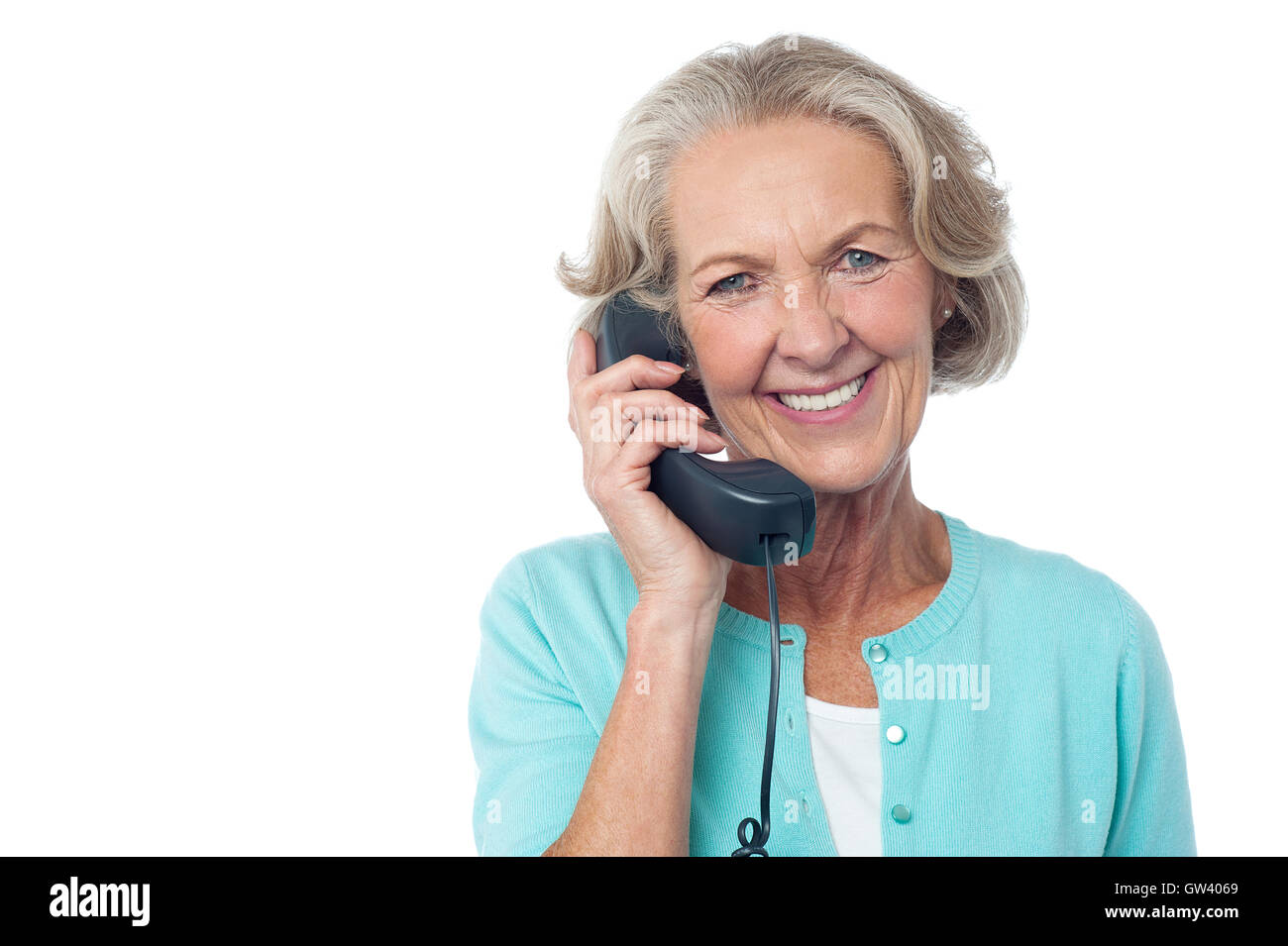 Senior lady holding phone receiver Stock Photo - Alamy