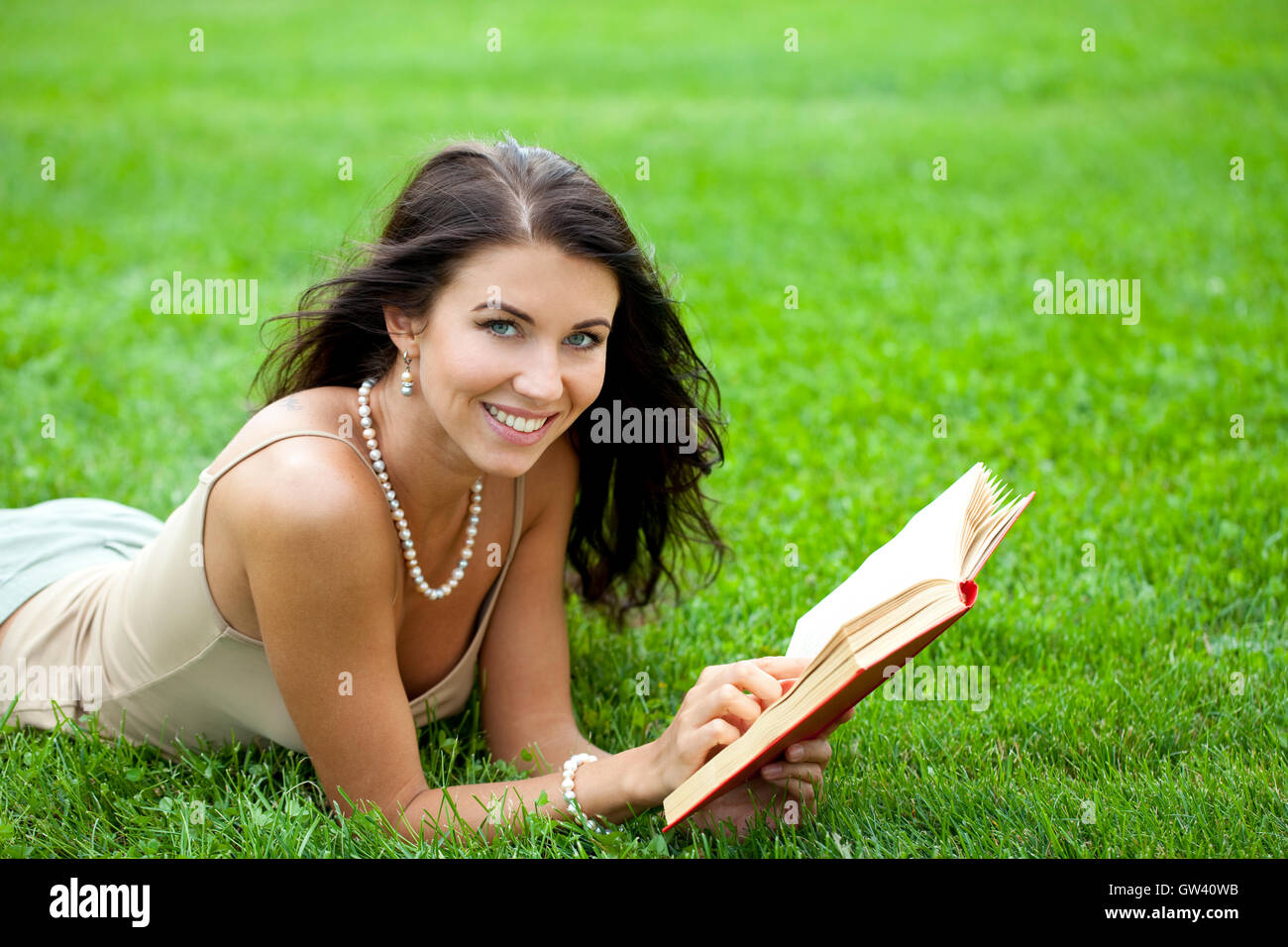 Young beautiful young woman reading a book outdoor Stock Photo - Alamy