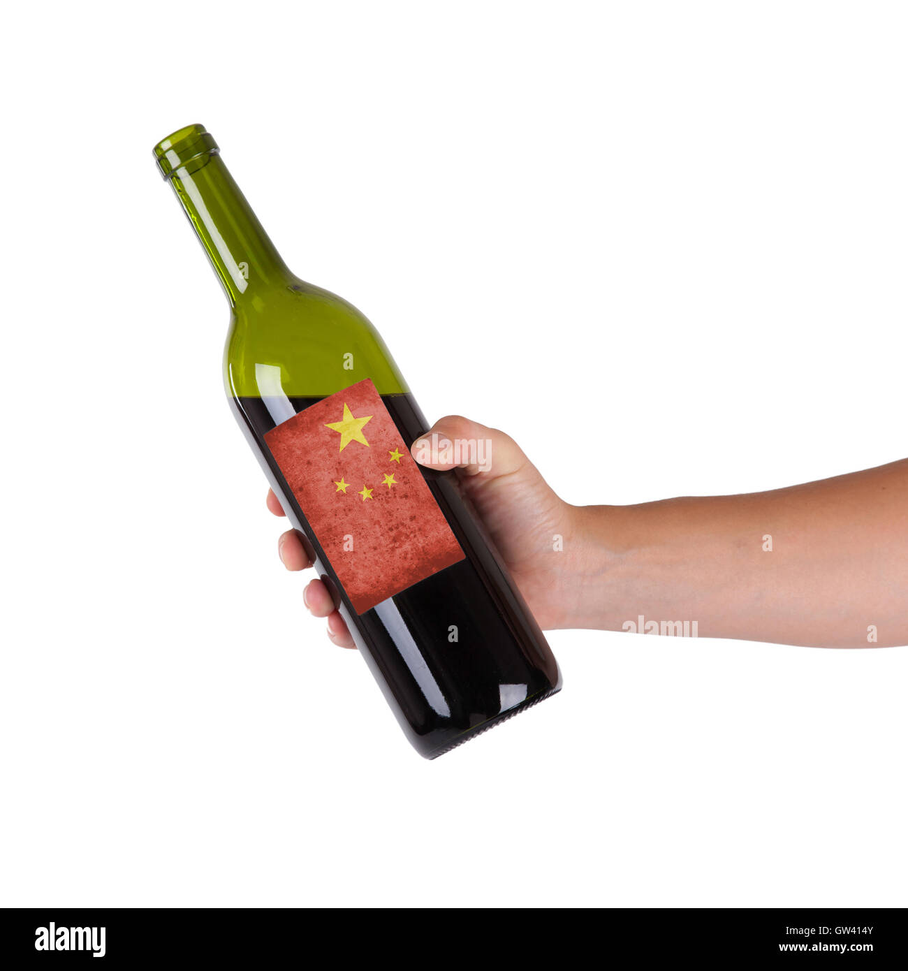 Hand holding a bottle of red wine Stock Photo - Alamy