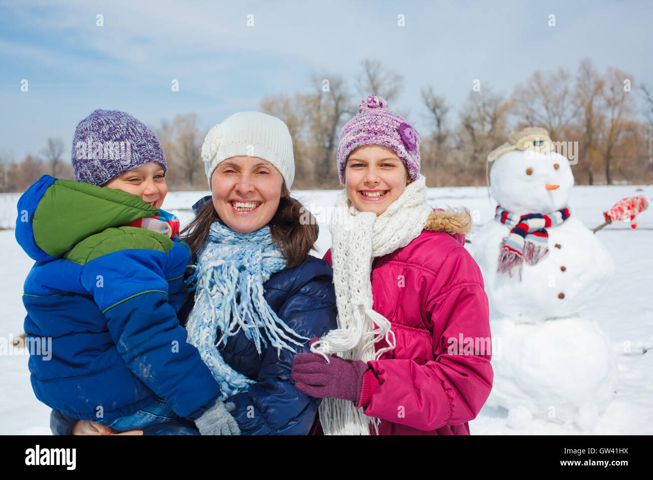 Family make a snowman Stock Photo - Alamy