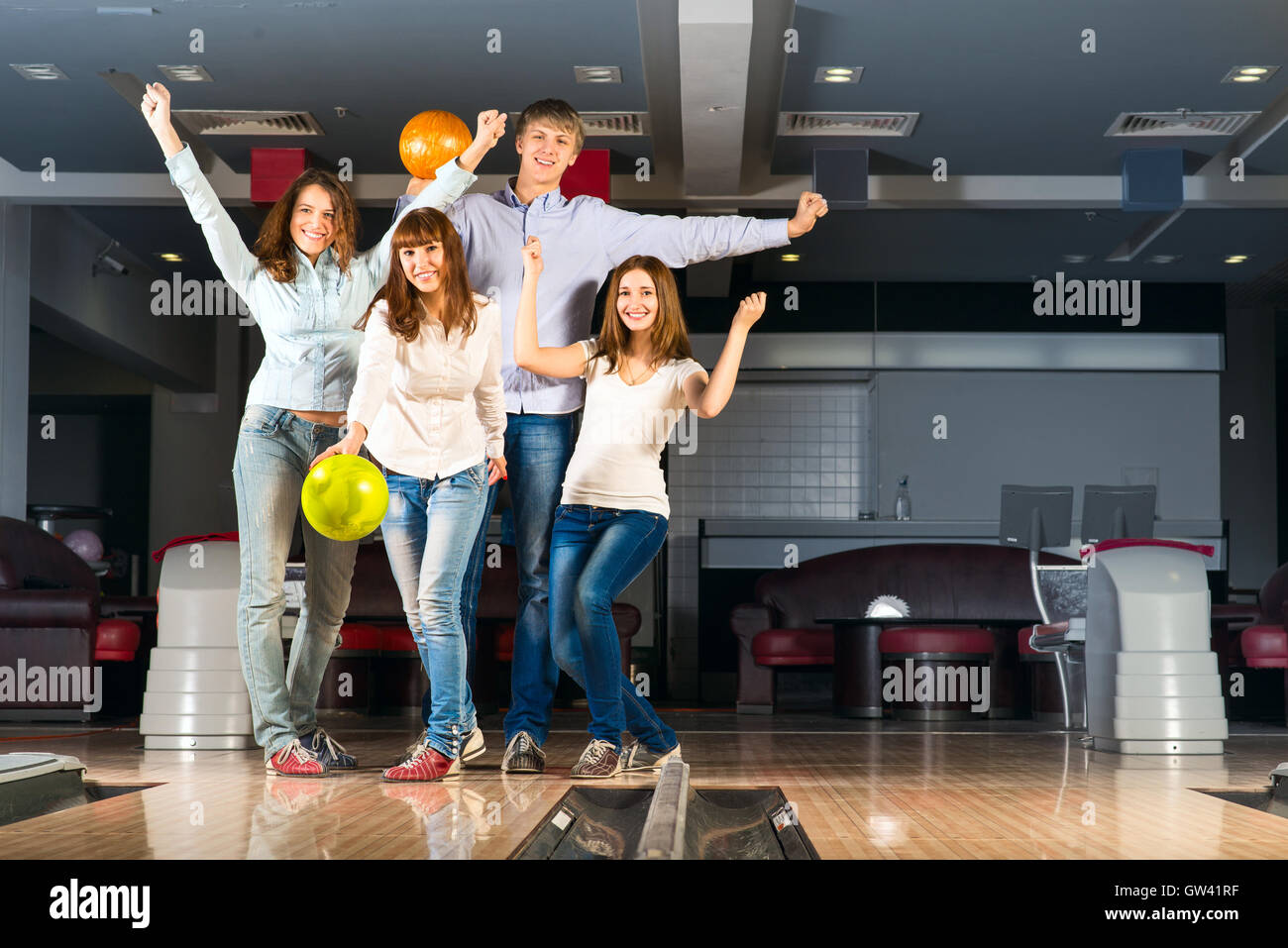 Group of young friends playing bowling Stock Photo - Alamy