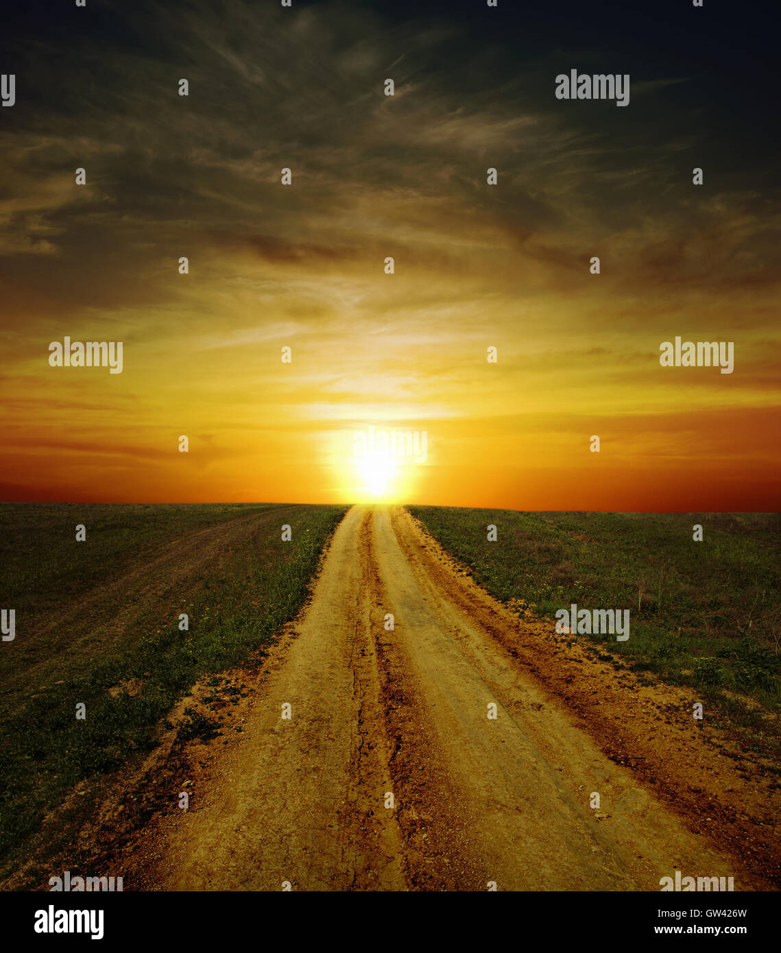 sunset over road Stock Photo - Alamy