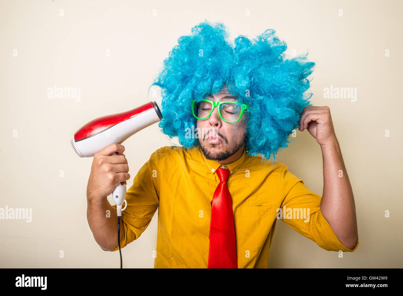 crazy funny young man with blue wig Stock Photo - Alamy