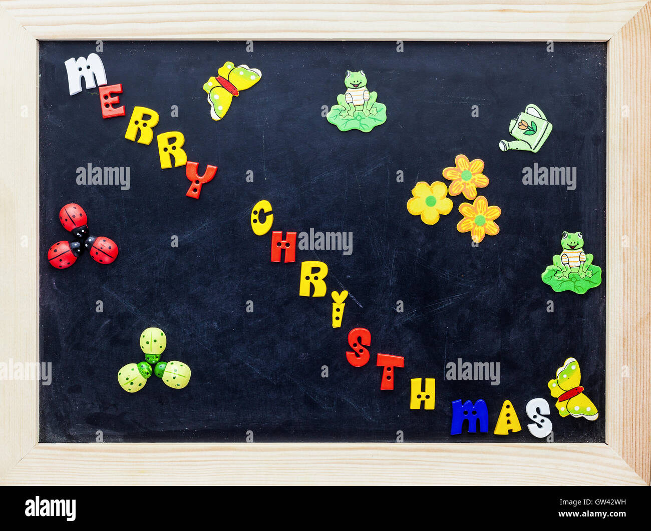 Color merry christmas words on black board Stock Photo - Alamy