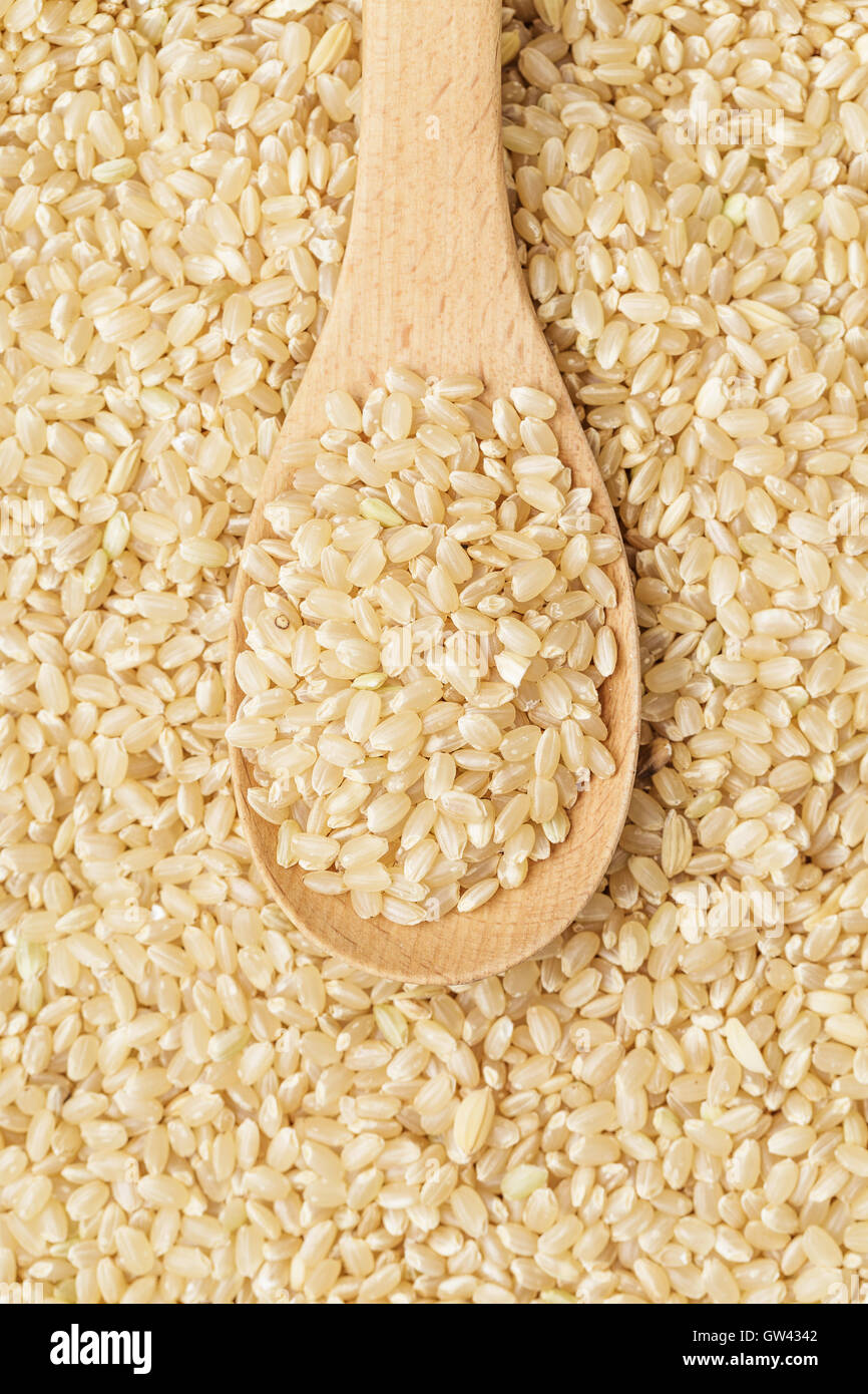 Brown rice on spoon Stock Photo - Alamy