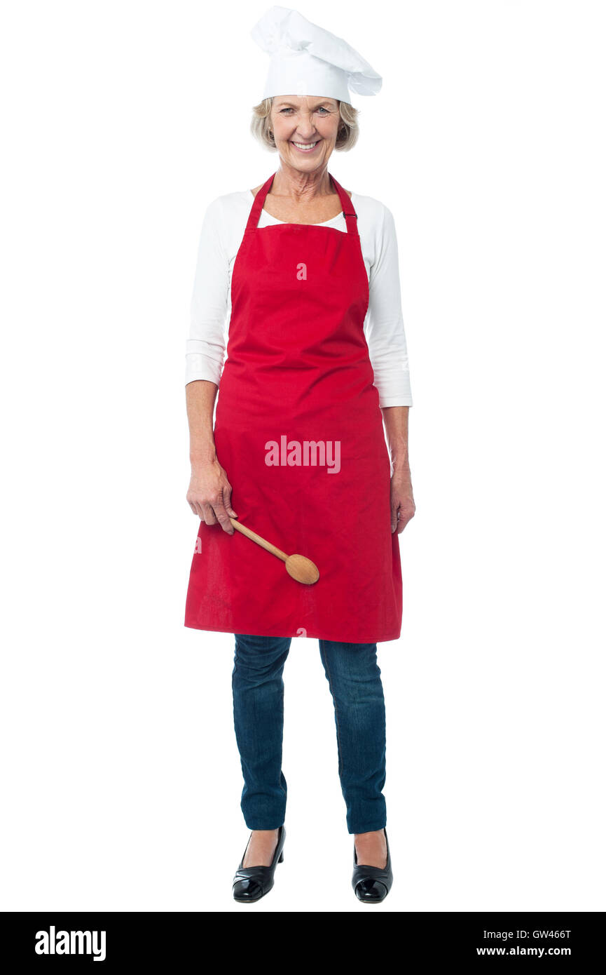 Cheerful senior female chef with spoon Stock Photo - Alamy