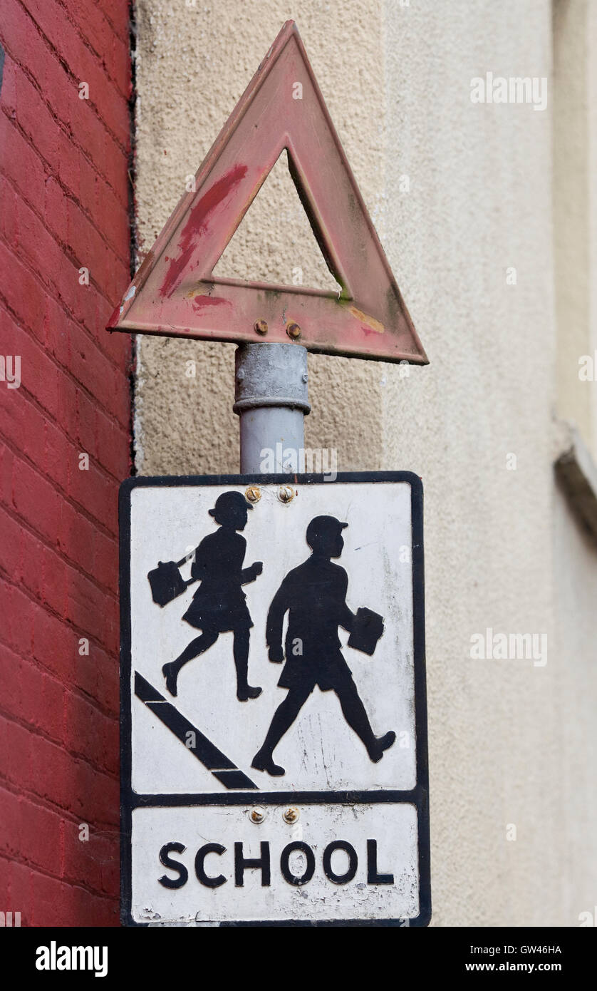 Old school crossing and warning triangle sign Stock Photo - Alamy