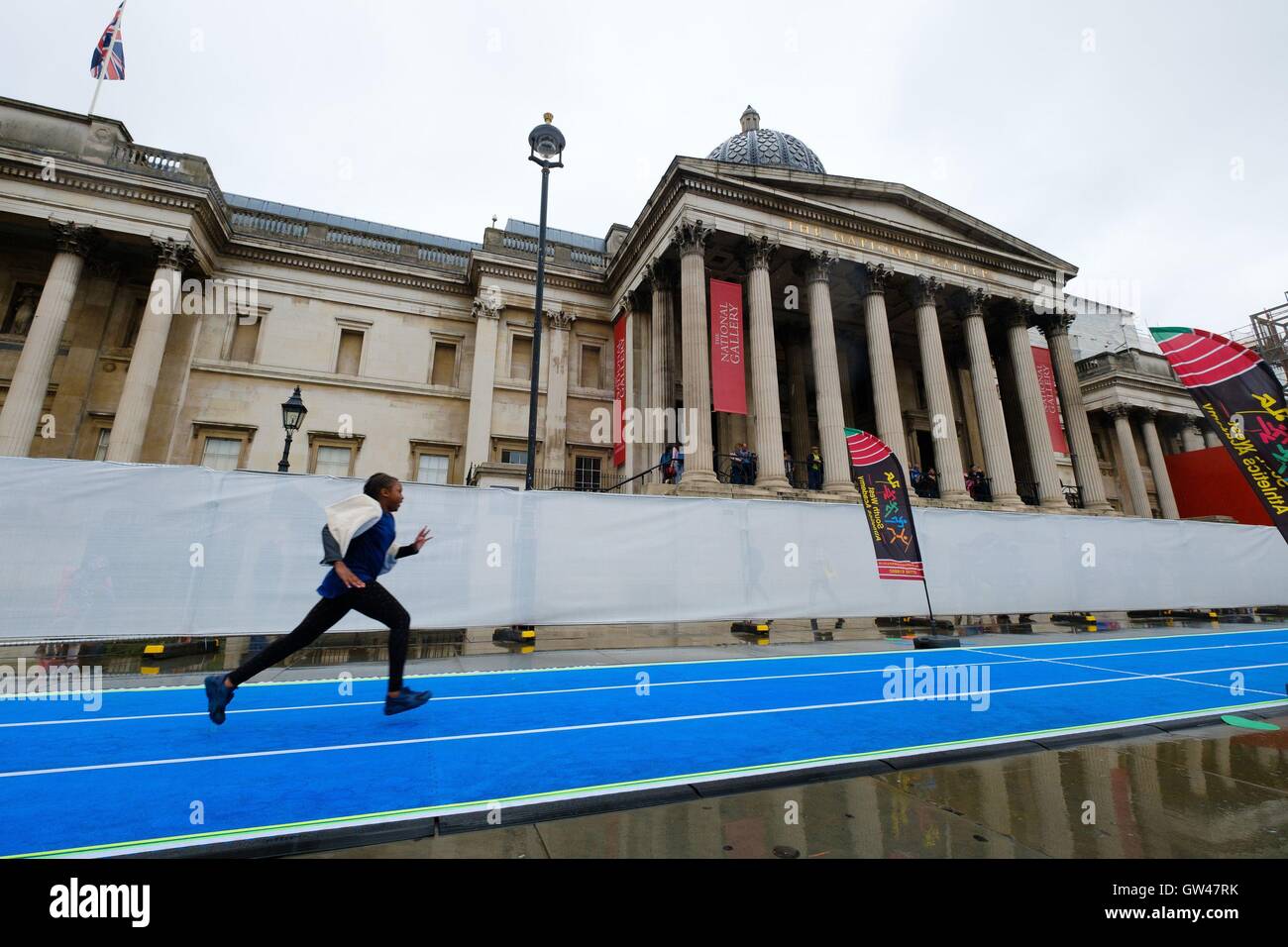 EDITORIAL USE ONLY A girl runs on a temporary running track as part of ...