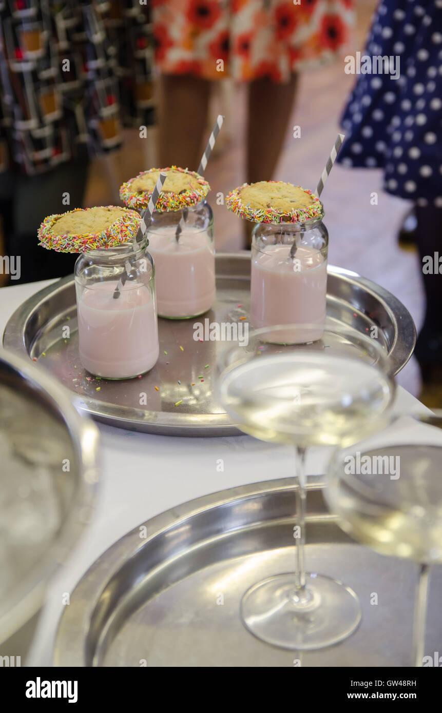 Fancy milk shake with cookie and straw at venue Stock Photo - Alamy
