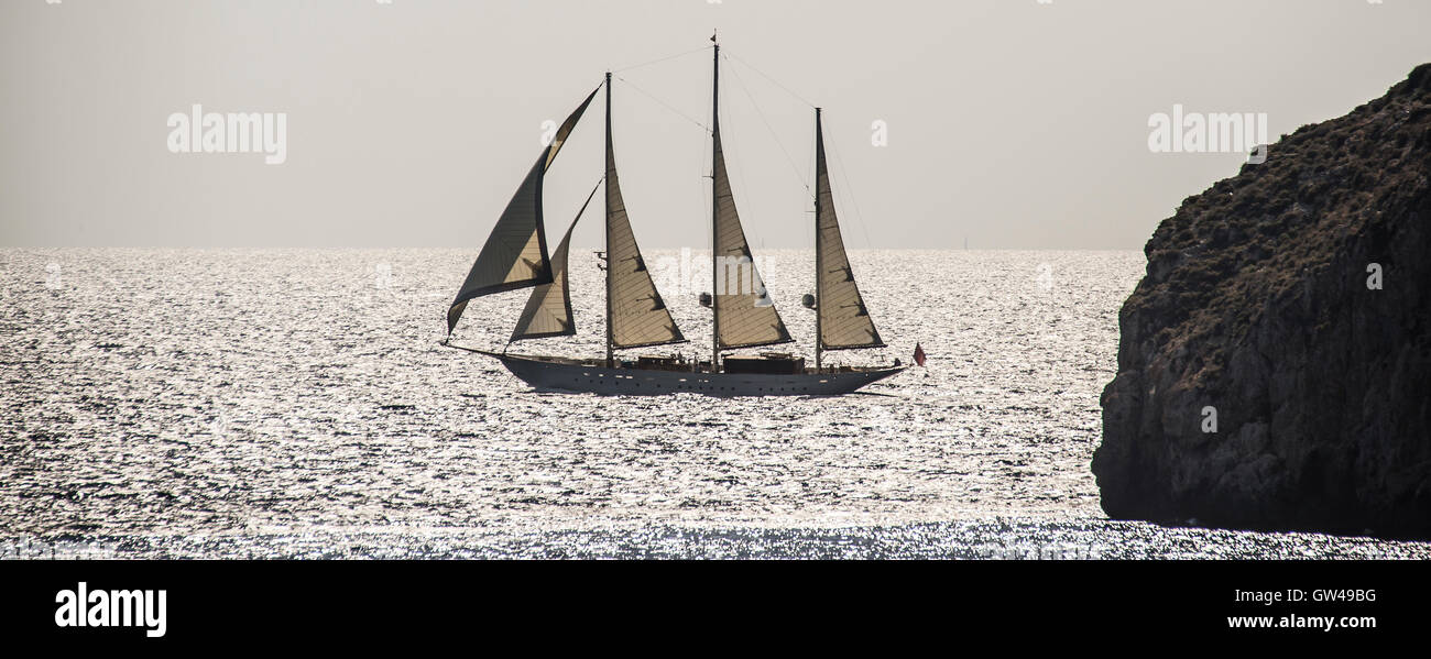 Three masted sailing boat in full sail on calm sea Stock Photo - Alamy