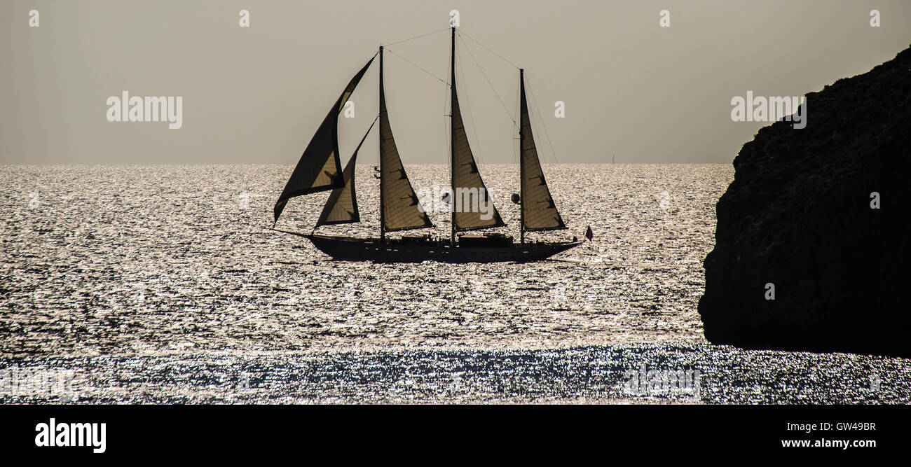 Three masted sailing boat in full sail on calm sea Stock Photo - Alamy