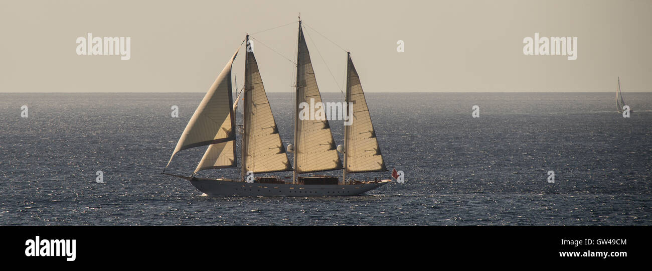 Three masted sailing boat in full sail on calm sea Stock Photo - Alamy