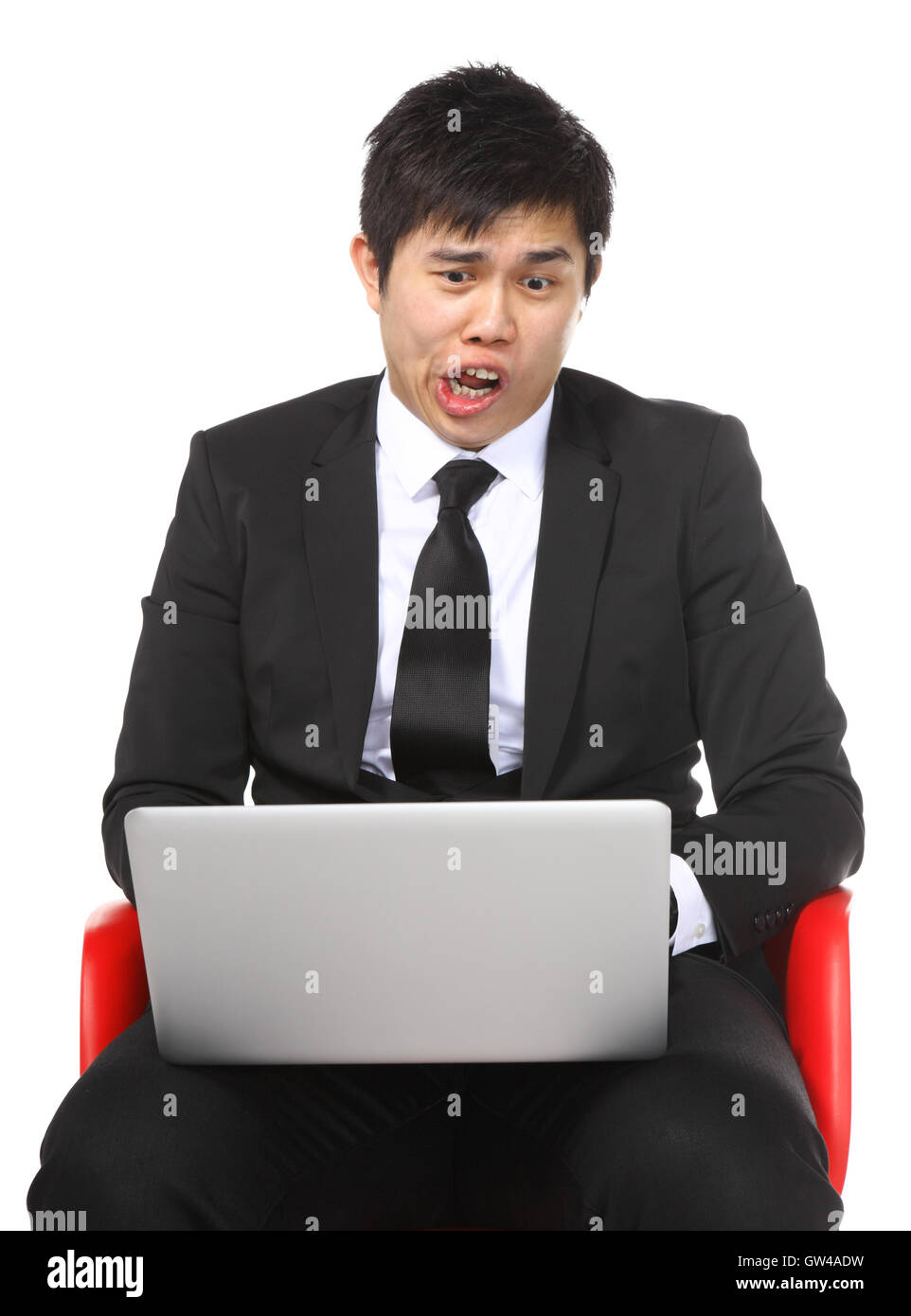 Asian businessman shocked surprise by laptop computer Stock Photo - Alamy