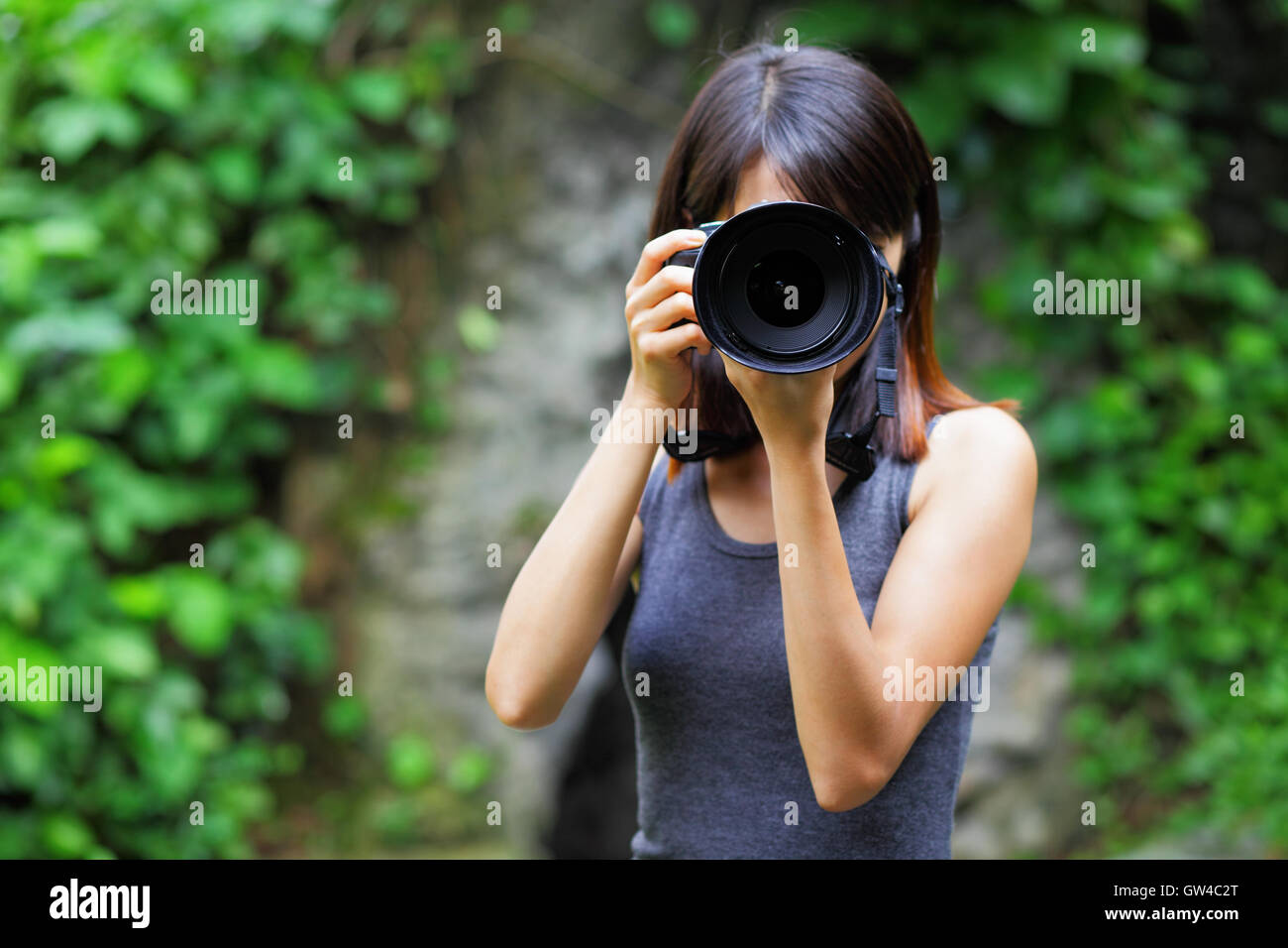 Asian woman taking photo Stock Photo - Alamy