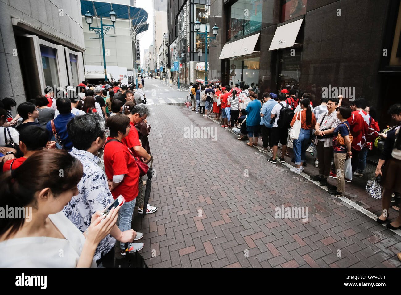 Hiroshima Carp baseball team fans line up outside Hiroshima Brand Shop ...