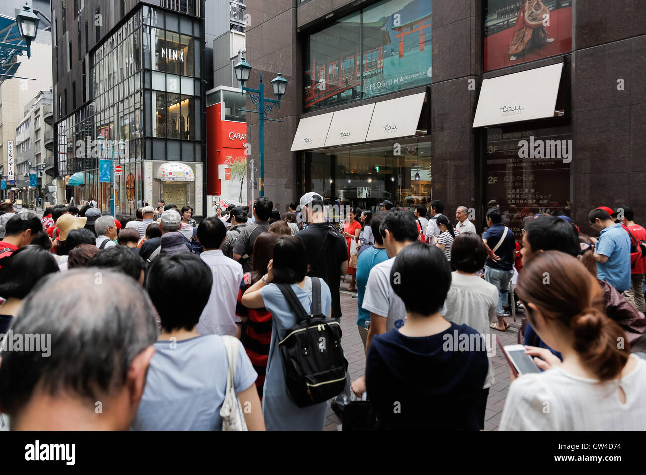Hiroshima Carp baseball team fans line up outside Hiroshima Brand Shop ...