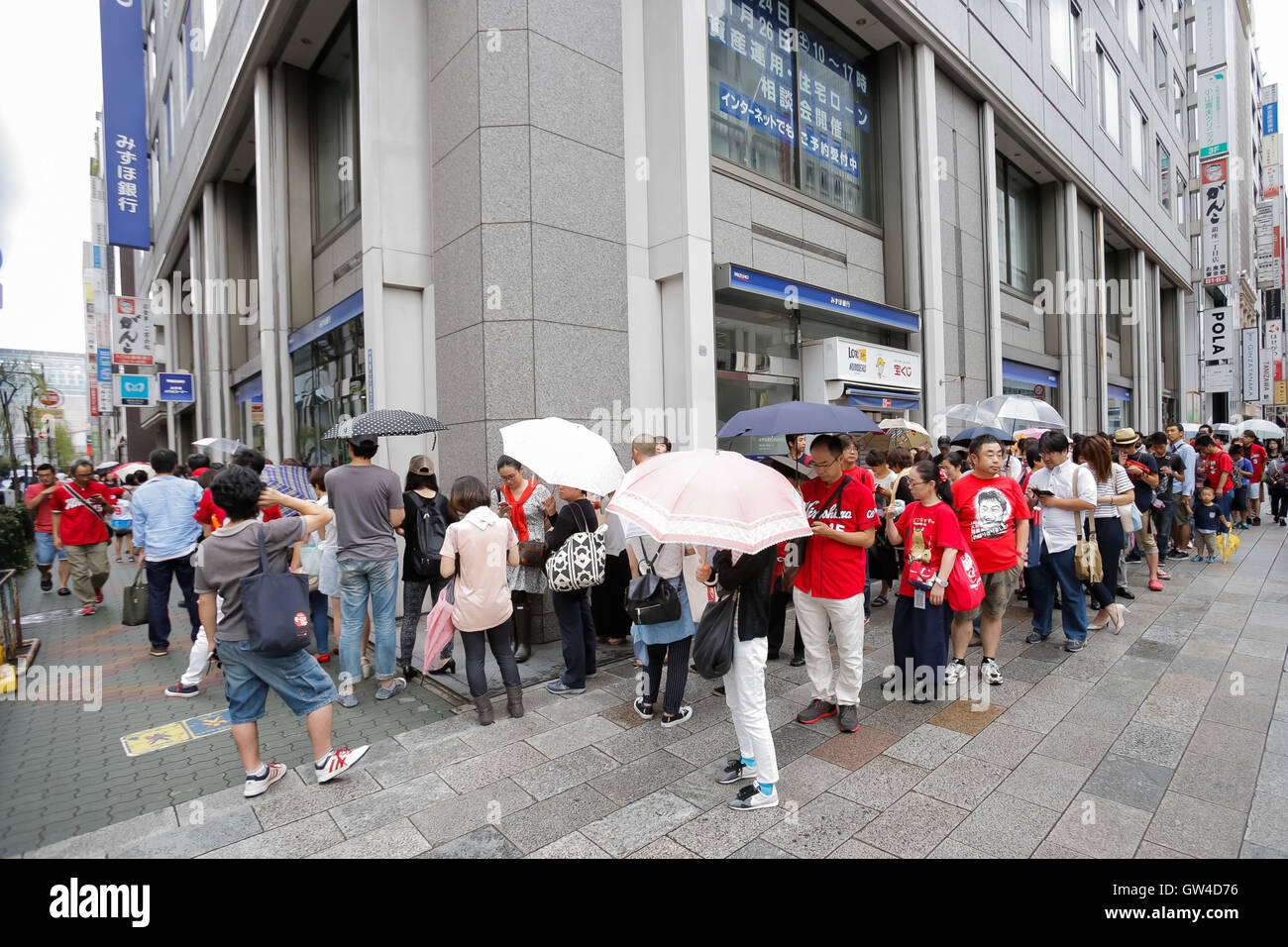 Hiroshima Carp baseball team fans line up along to the main street of ...