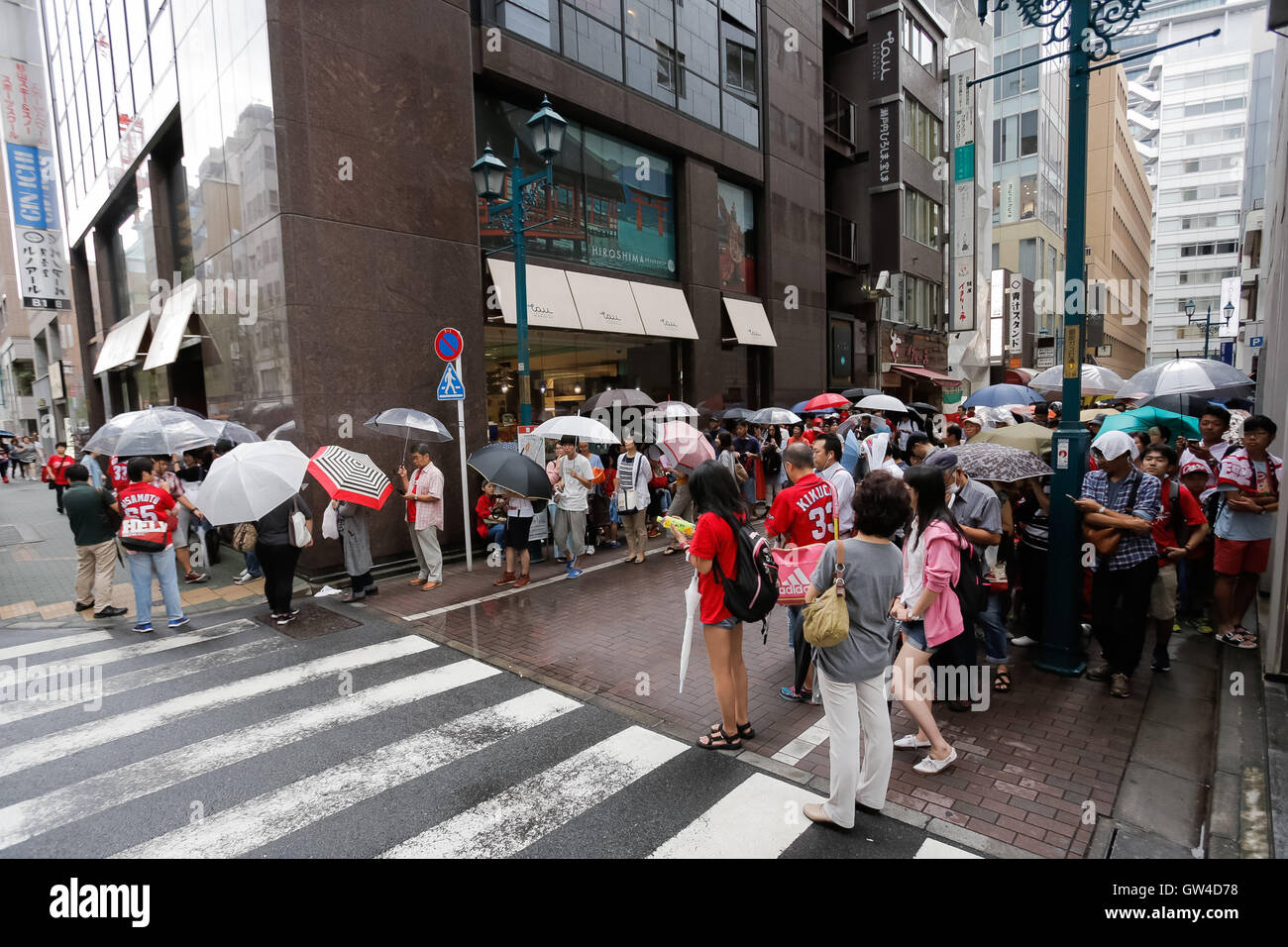 Hiroshima Carp baseball team fans line up outside Hiroshima Brand Shop ...