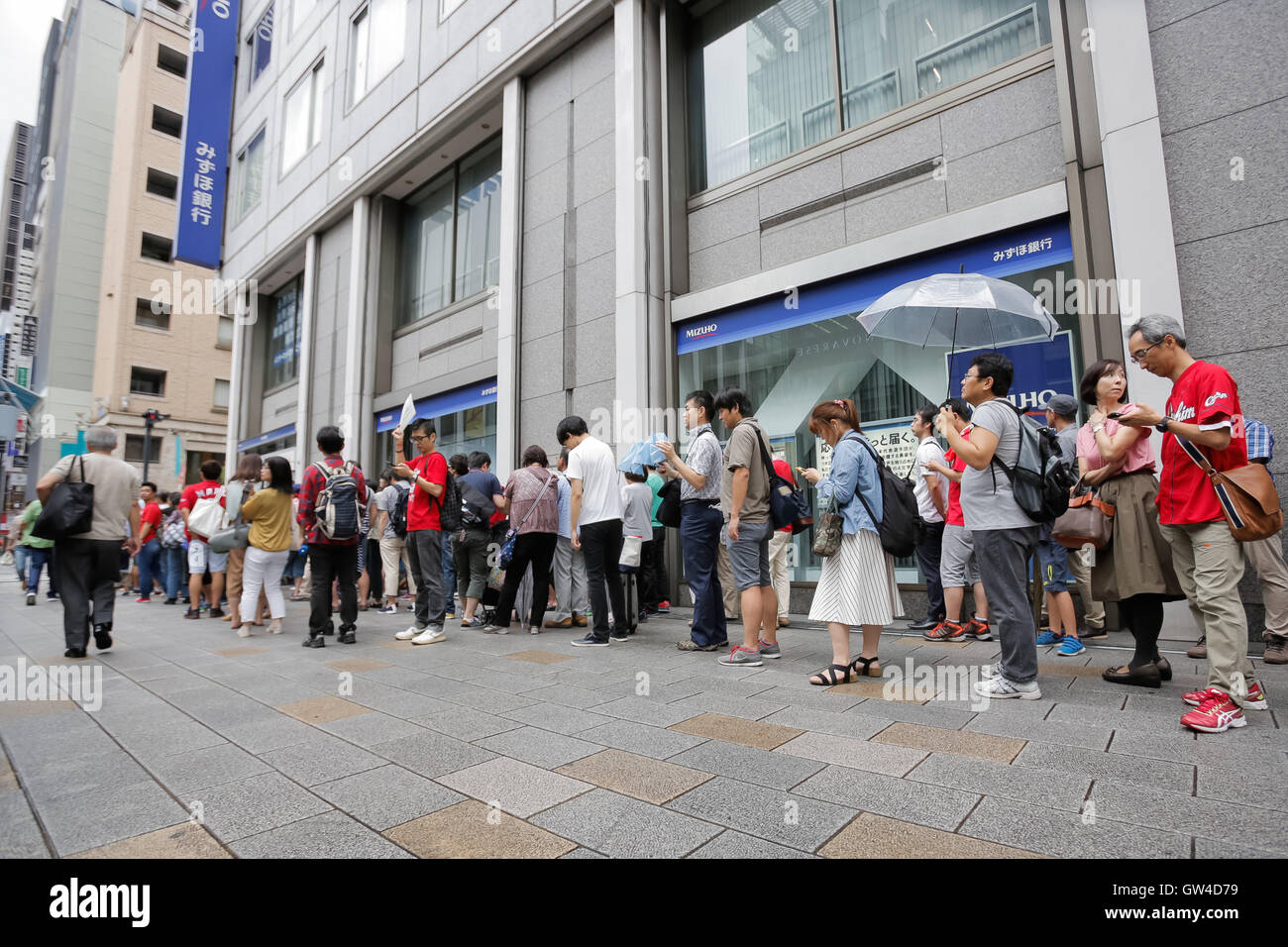 Hiroshima Carp baseball team fans line up along to the main street of ...