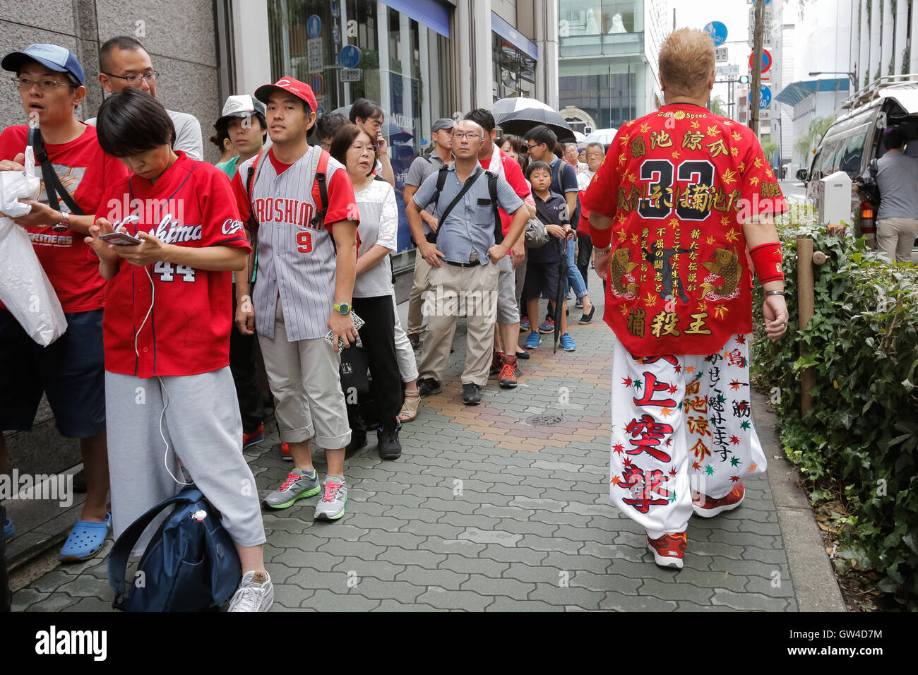 Hiroshima Carp baseball team fans line up near to Hiroshima Brand Shop ...