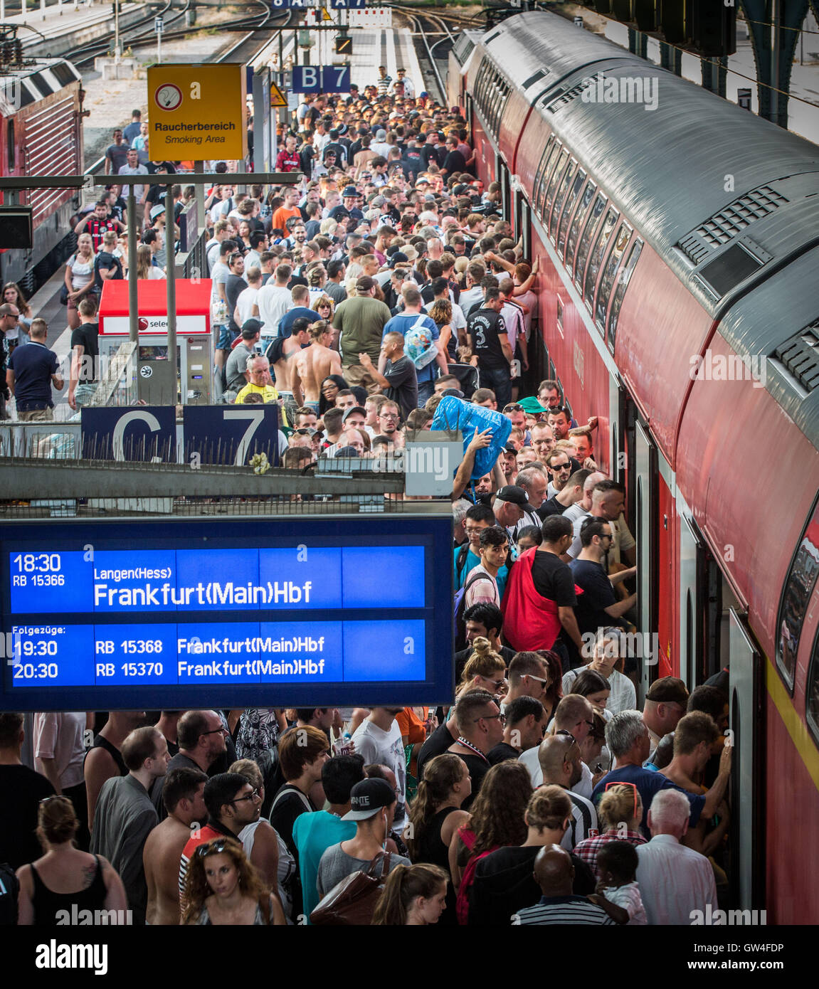 Hundreds of fans of Eintracht Frankfurt entering a train to Darmstadt ...