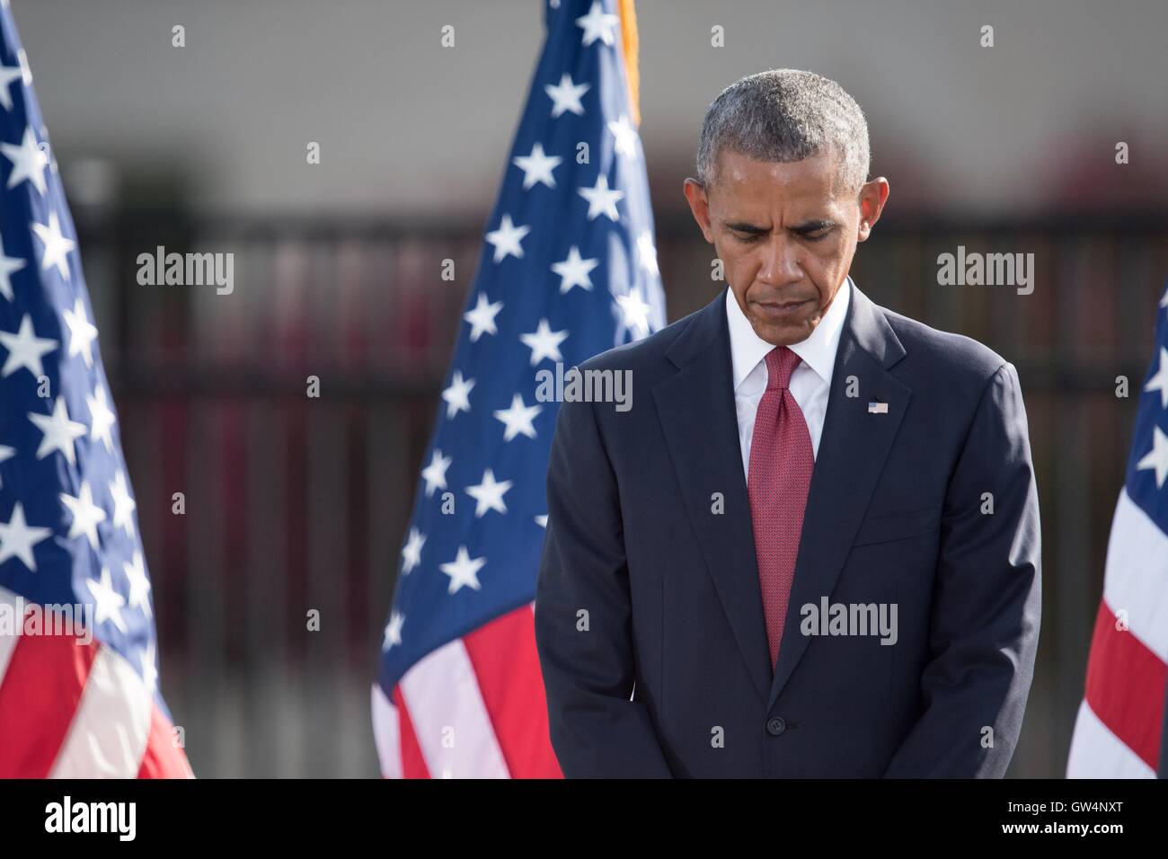 U.S President Barack Obama bows his head during a moment of silence at ...