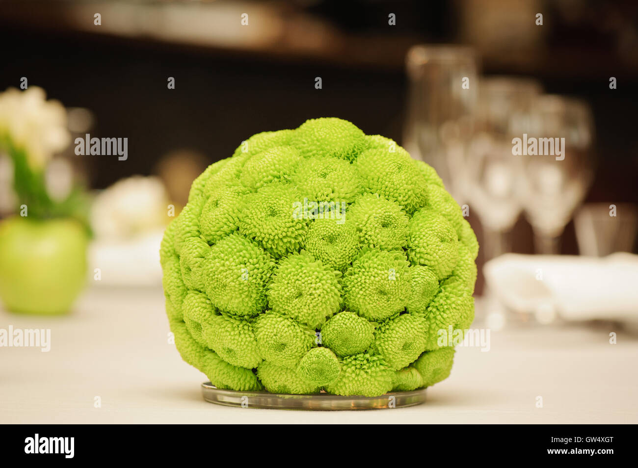 Round floral arrangement on the Bridal table in green color. Wedding ...