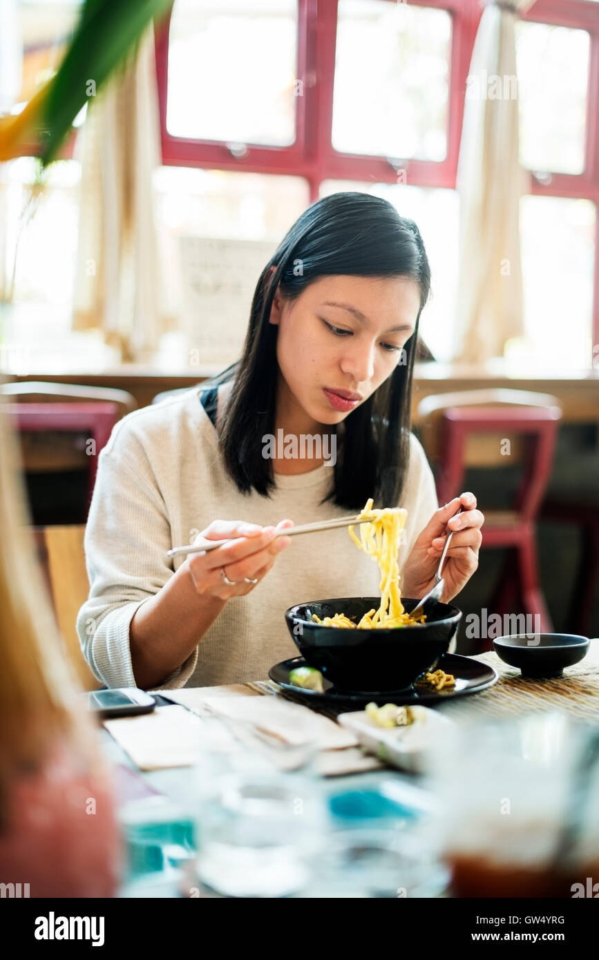 Asian girl eating noodles restaurant hi-res stock photography and ...