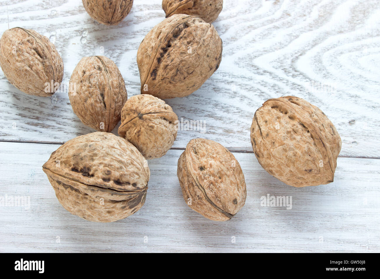 Walnuts on white wooden background Stock Photo - Alamy