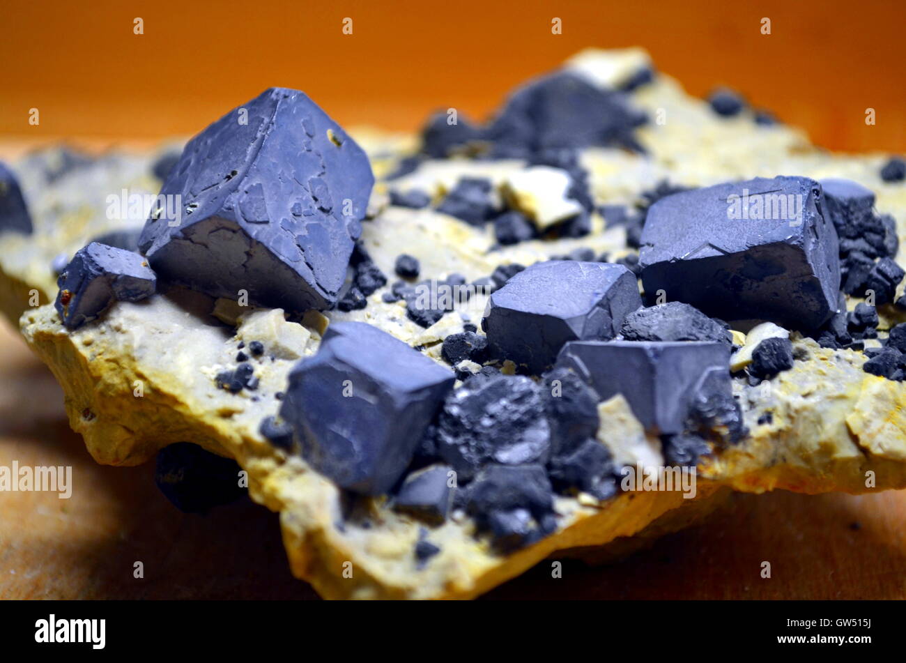 detail of dark blocky ore minerals on a white rock Stock Photo - Alamy