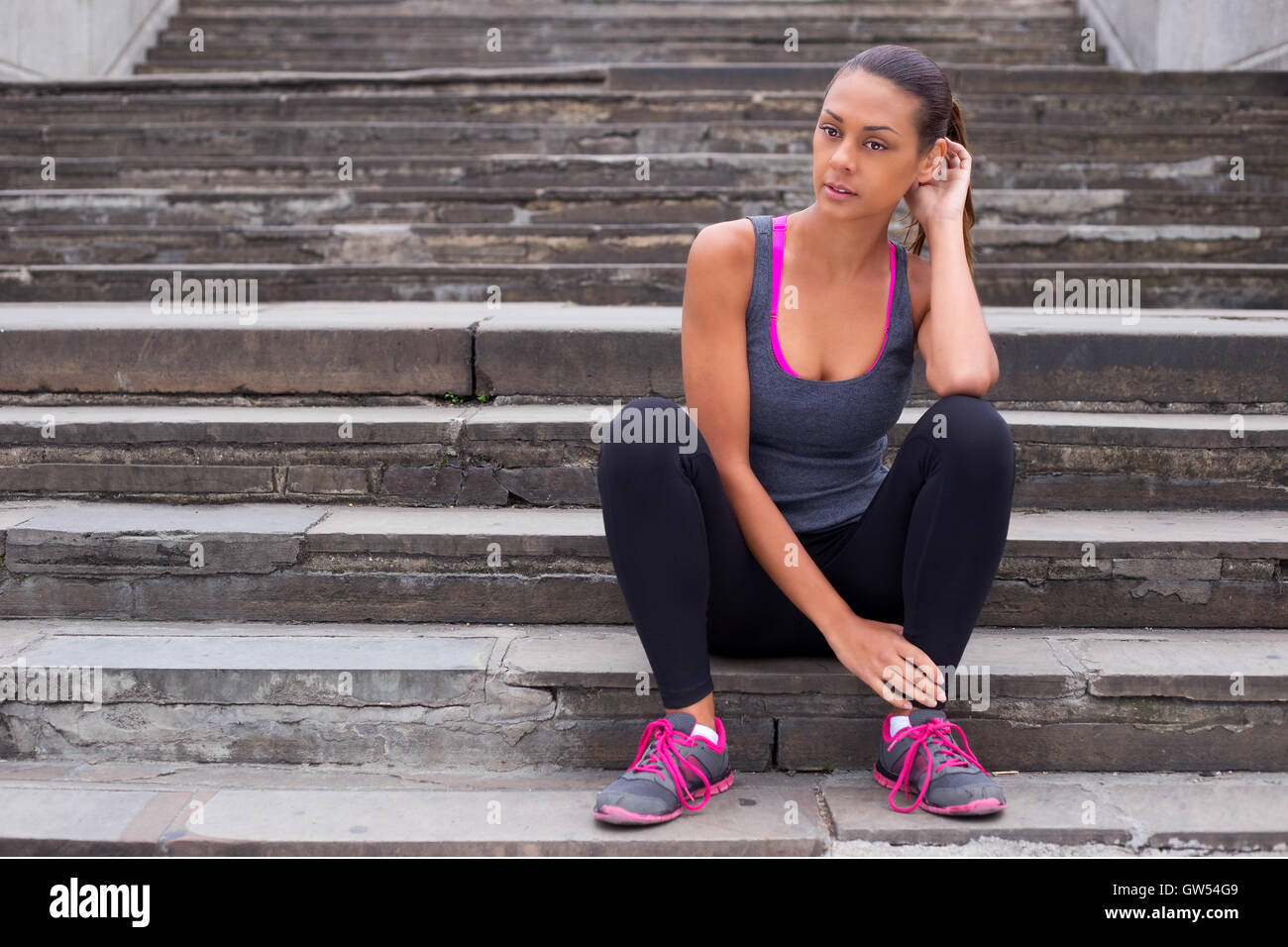 Fitness woman sitting on steps hi-res stock photography and images - Alamy