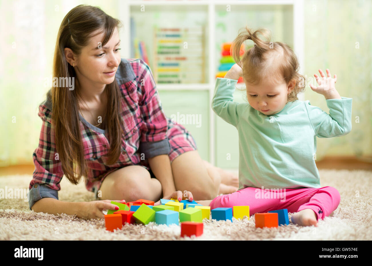 kid toddler and mother play wooden toys at home or nursery Stock Photo ...