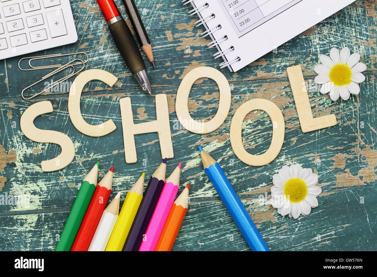 Word school written with wooden letters with stationery items spread ...