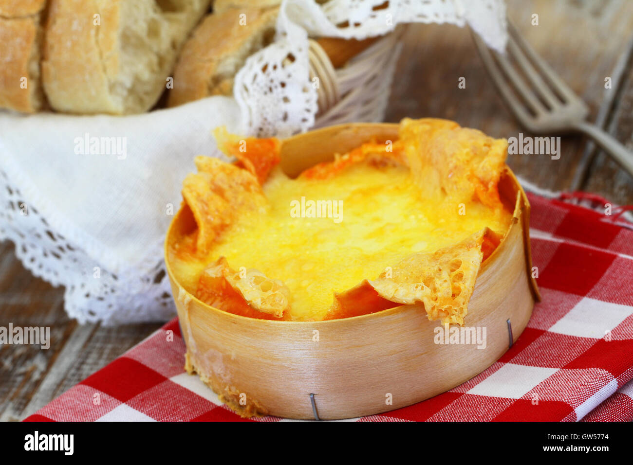 Traditional baked cheese with rustic bread Stock Photo - Alamy