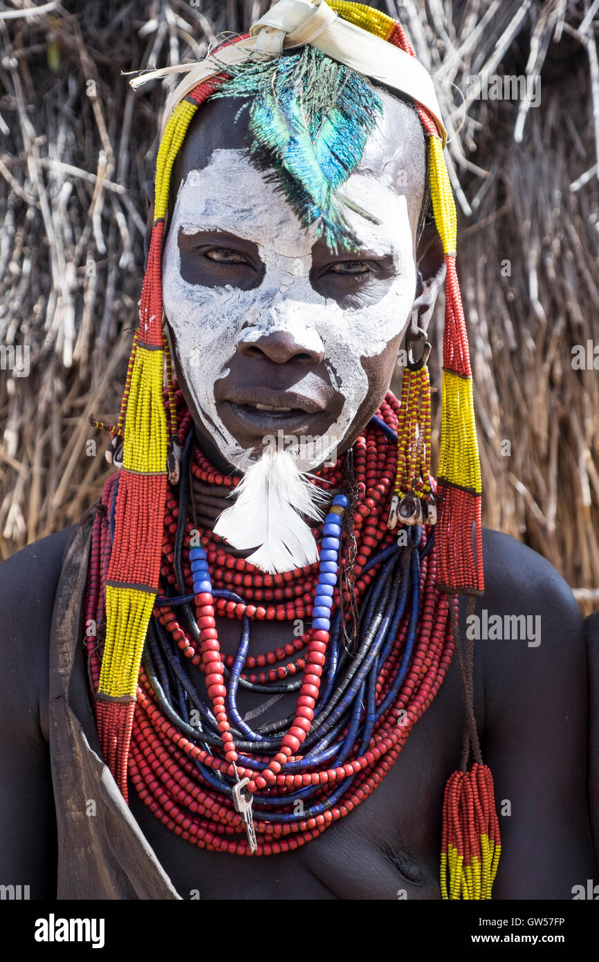 Woman of the Karo tribe in the Omo Valley of Ethiopia stands in front ...