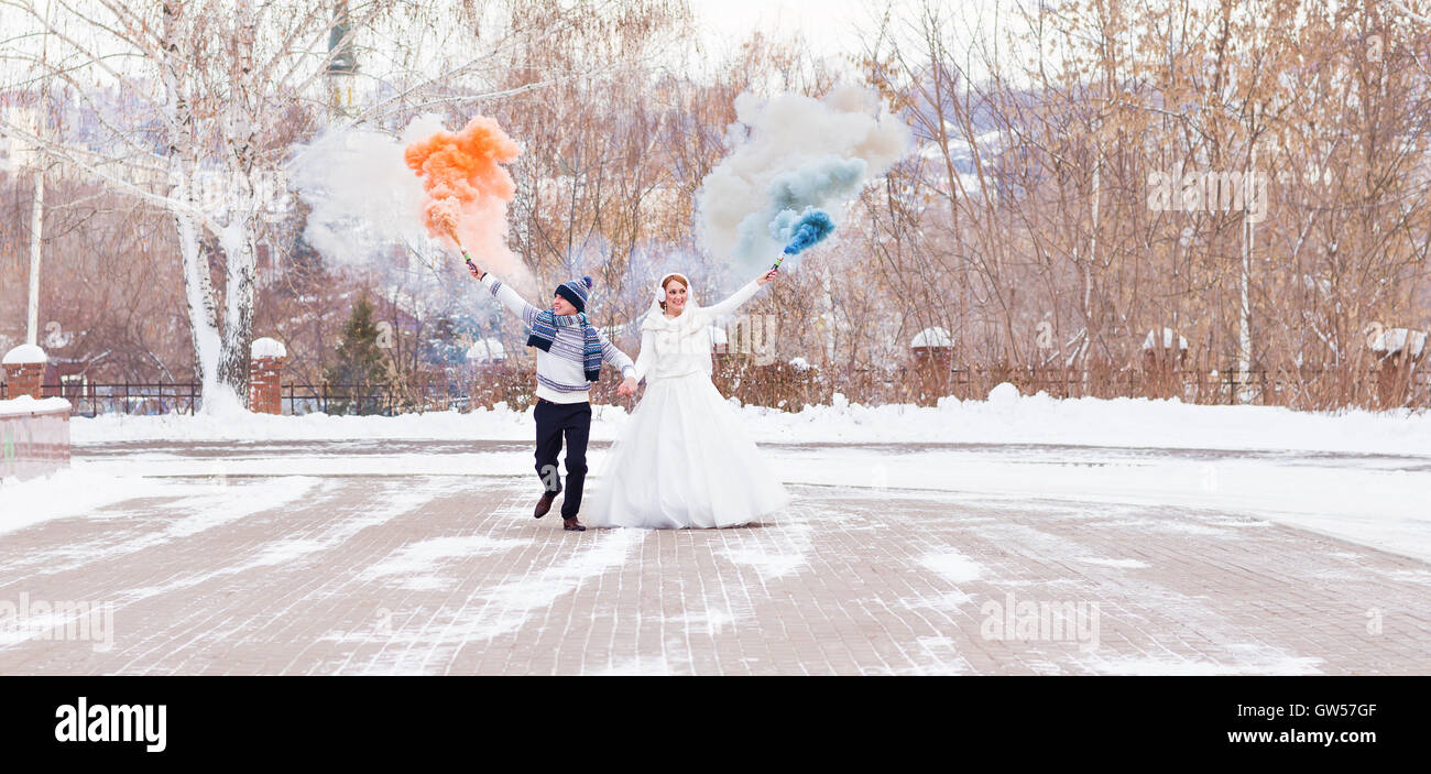 Bride and groom have fun on their winter wedding Stock Photo - Alamy