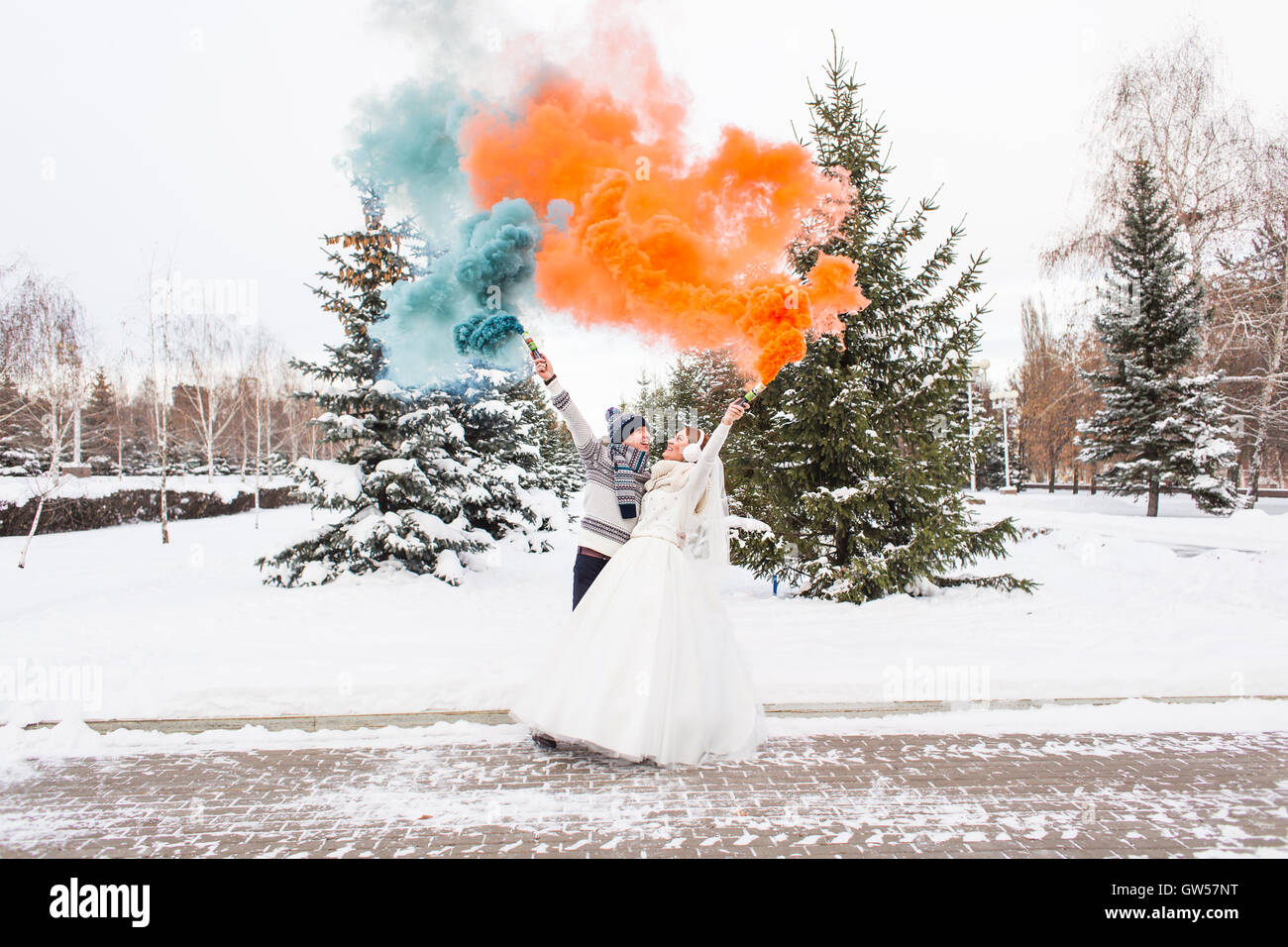 Bride and groom have fun on their winter wedding Stock Photo - Alamy