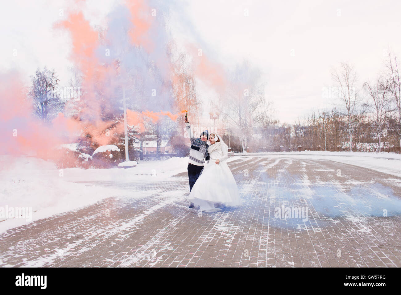 Bride and groom have fun on their winter wedding Stock Photo - Alamy