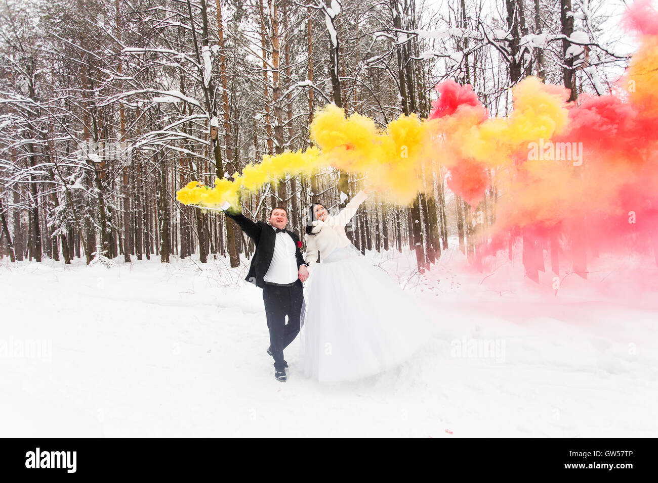 Bride and groom have fun on their winter wedding Stock Photo - Alamy