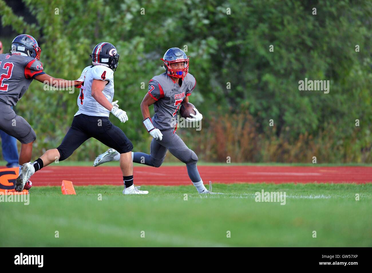 A high school defensive back crossing the goal line to pay dirt ...