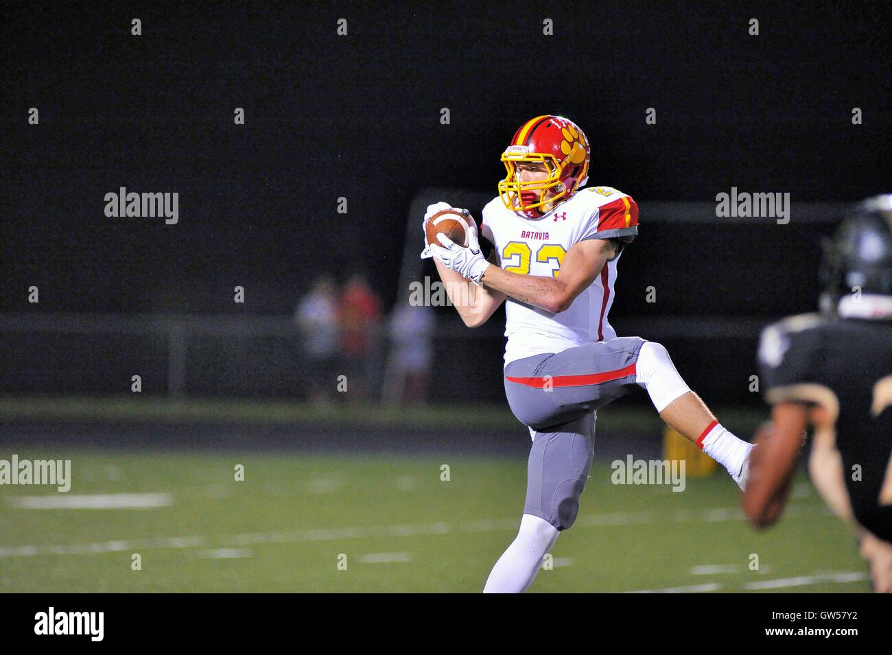 Wide receiver making a pass reception over the middle of the field for ...
