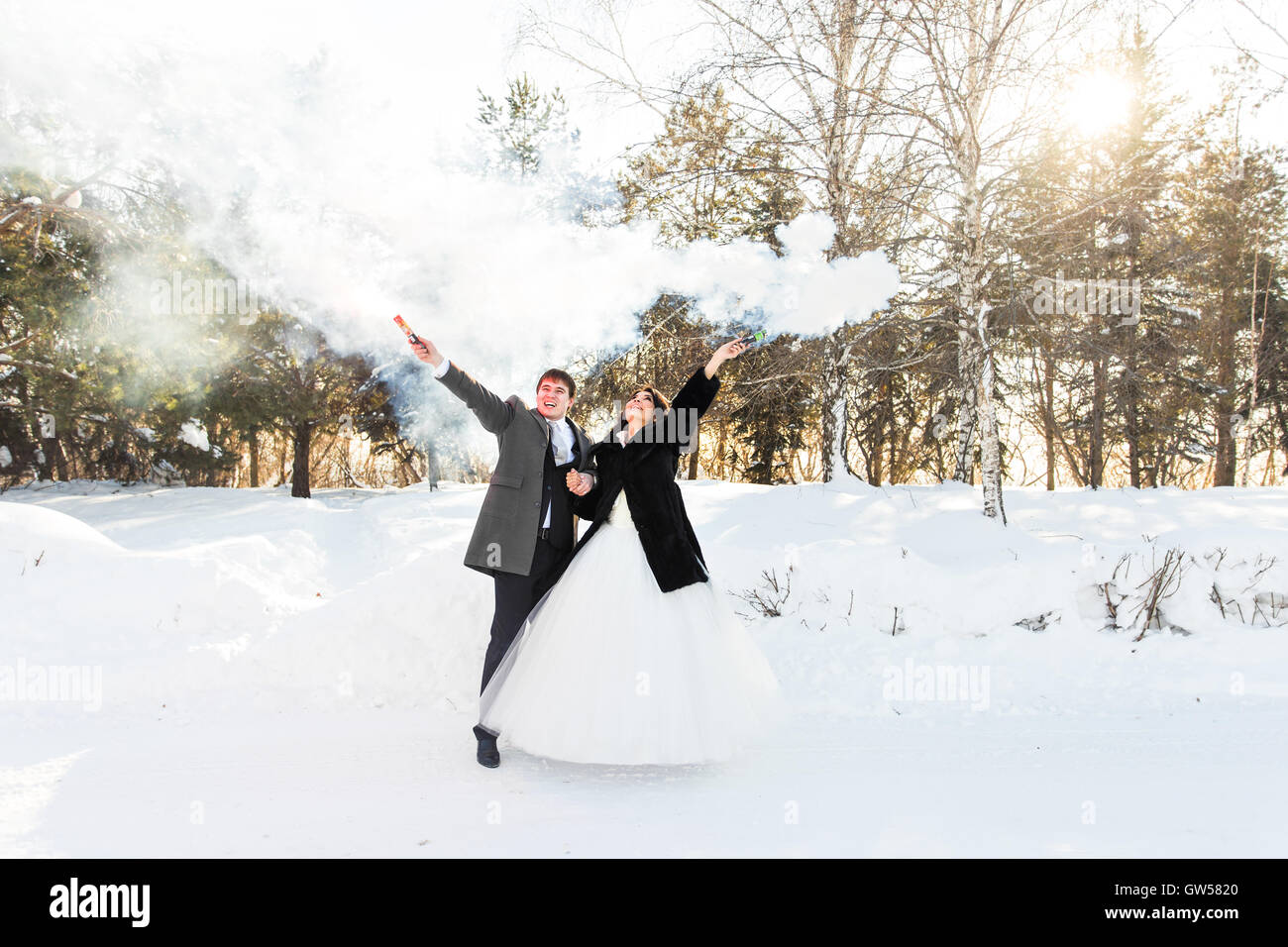 Bride and groom have fun on their winter wedding Stock Photo - Alamy