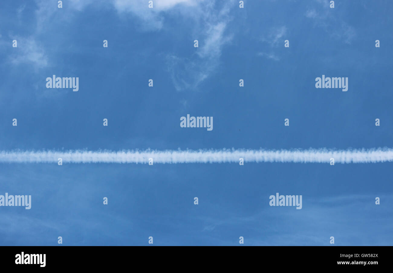 white stripe on the airplane in the blue cloudless sky Stock Photo - Alamy