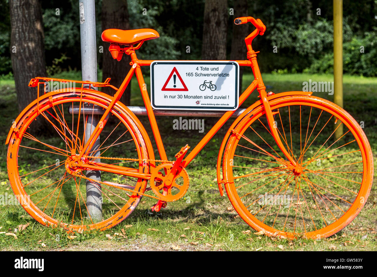 Ghost Bike, orange painted bicycle as a memorial to a traffic accident ...