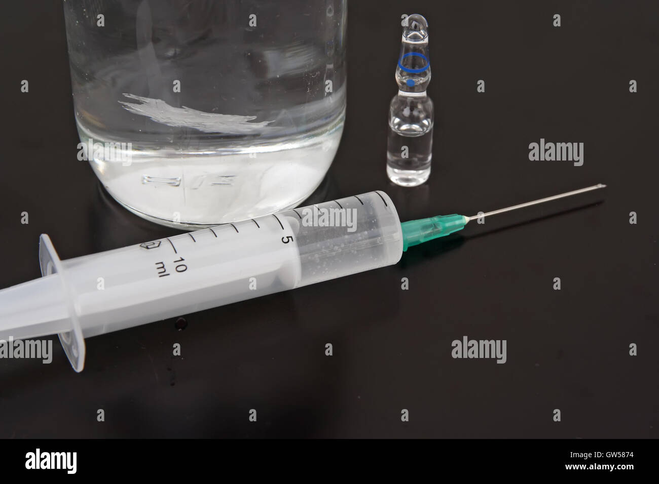 Medical syringe and a cure in ampule and bottle Stock Photo - Alamy
