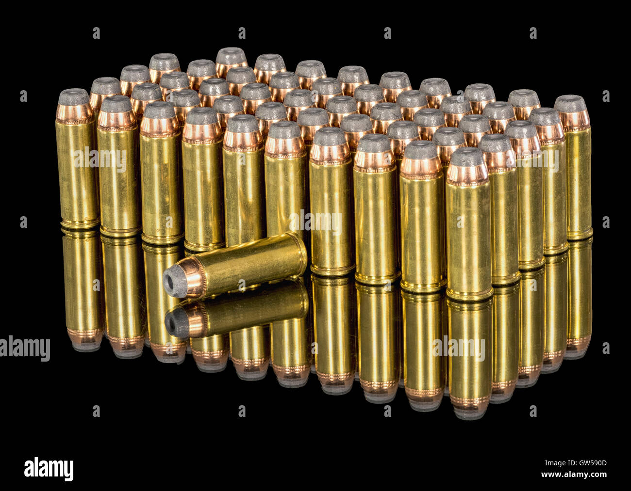 Pack of pistol bullets standing in rows with one on its side Stock ...
