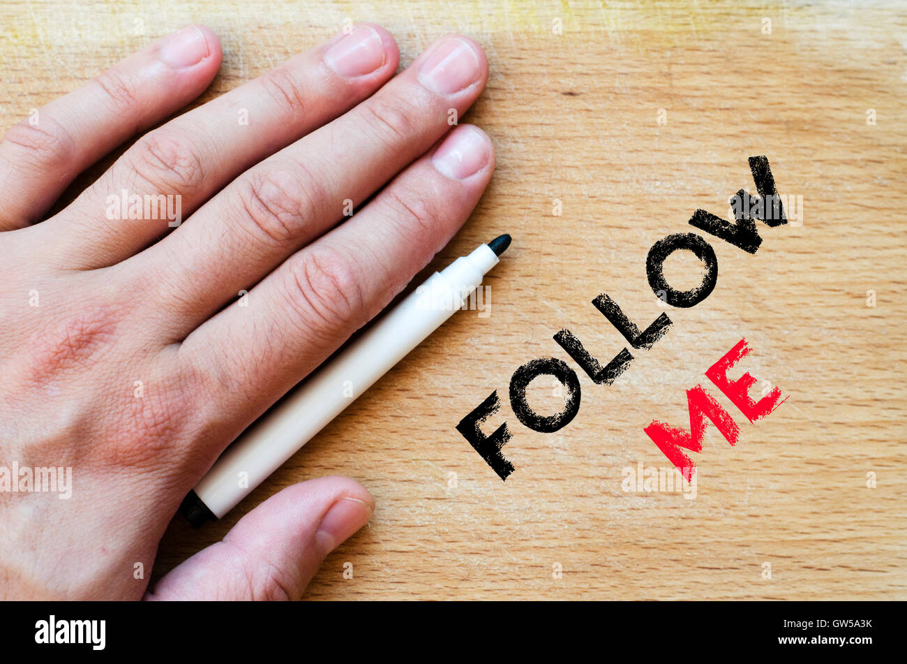 Human hand over wooden background and follow me text concept Stock ...