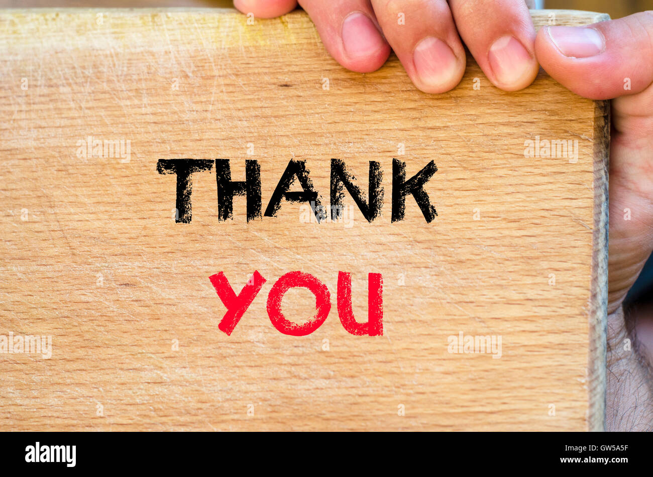 Human hand over wooden background and thank you text concept Stock ...
